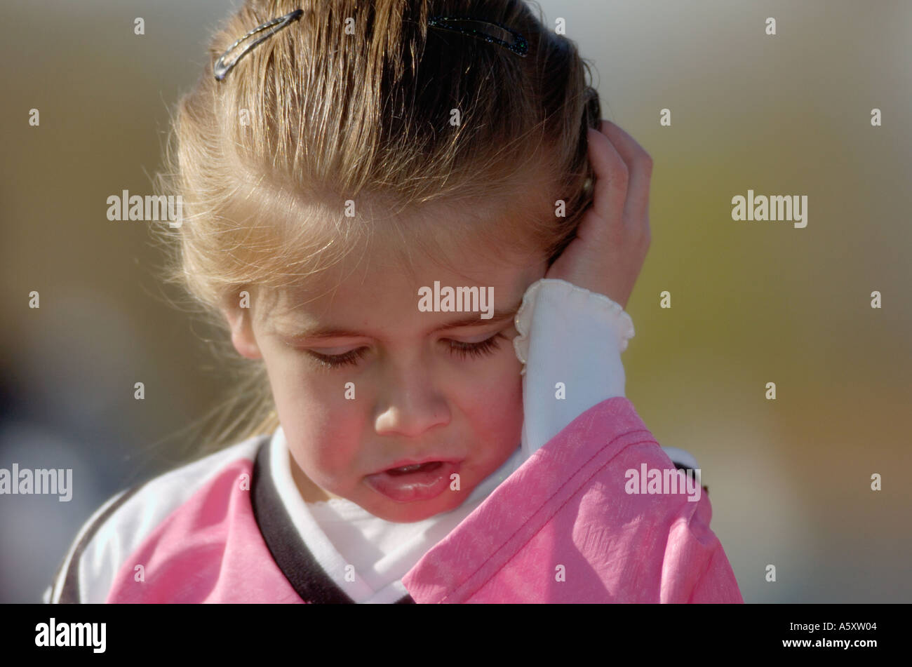 Young girl in Soccer uniform looking sad and crying Stock Photo - Alamy