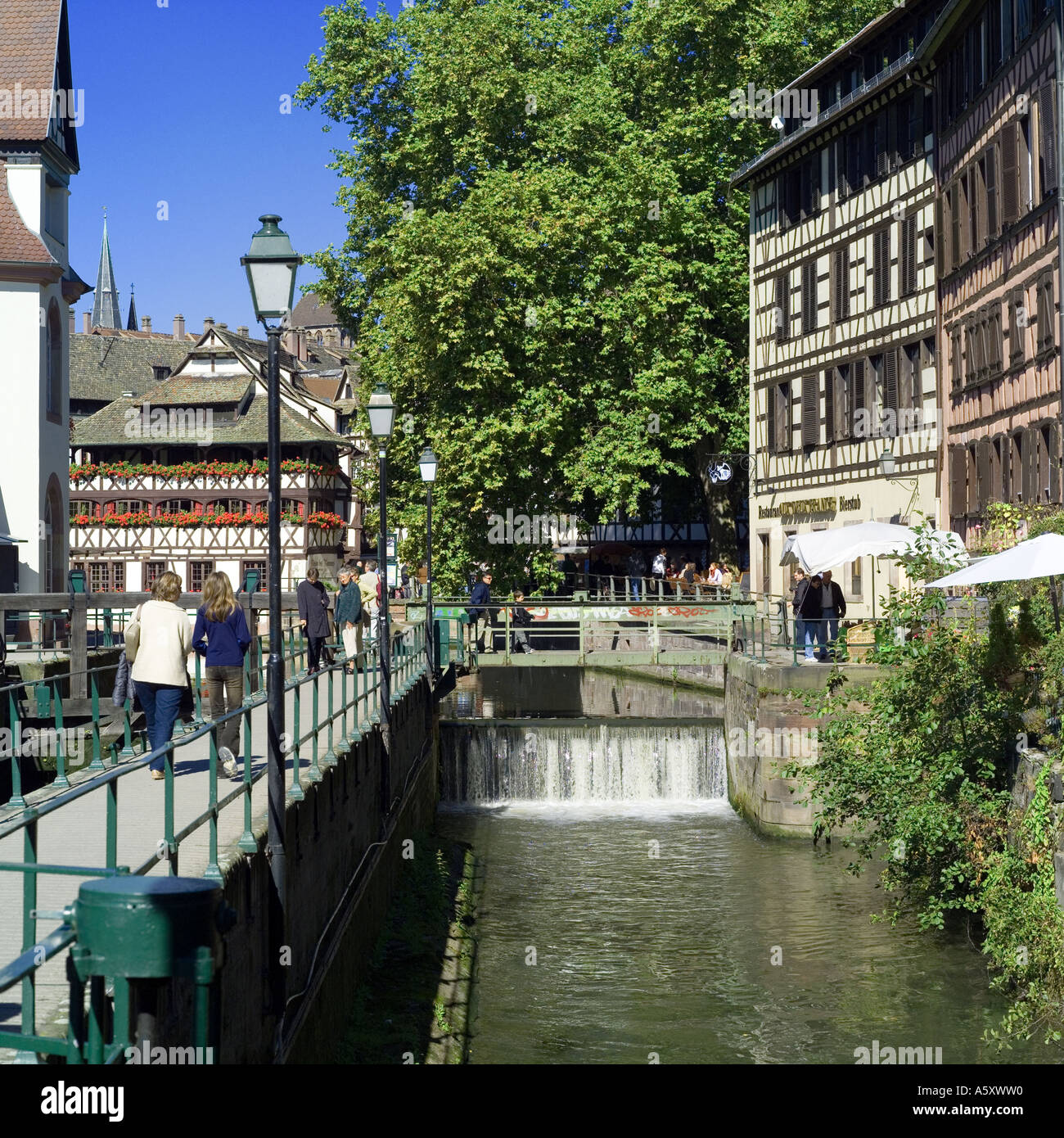 Footbridge and lock on Ill river, half-timbered houses, La Petite ...