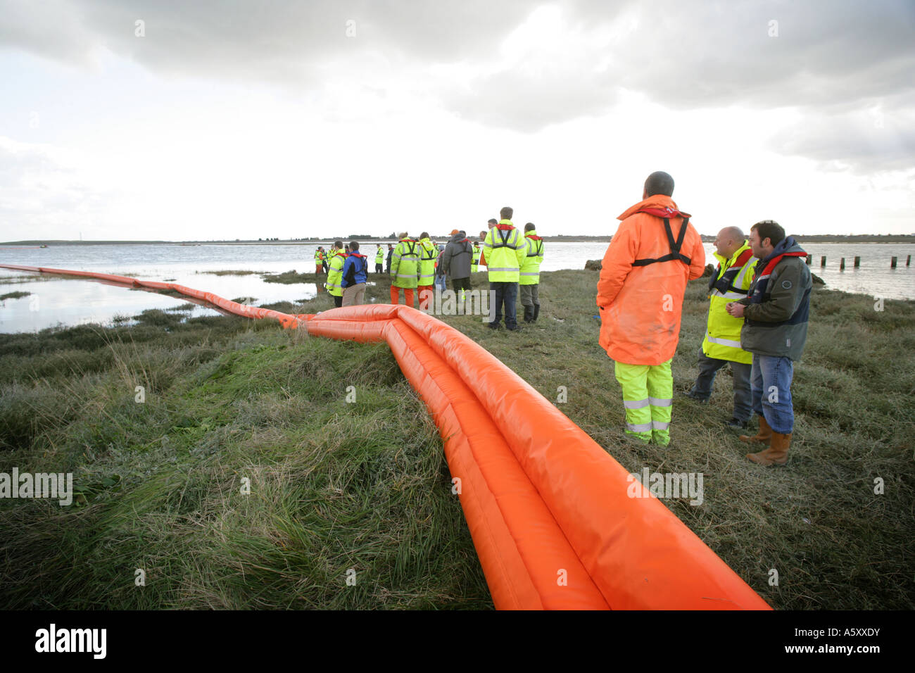 EMERGENCY WORKERS PUT A BOOM IN PLACE during a mock oil spill exercise ...