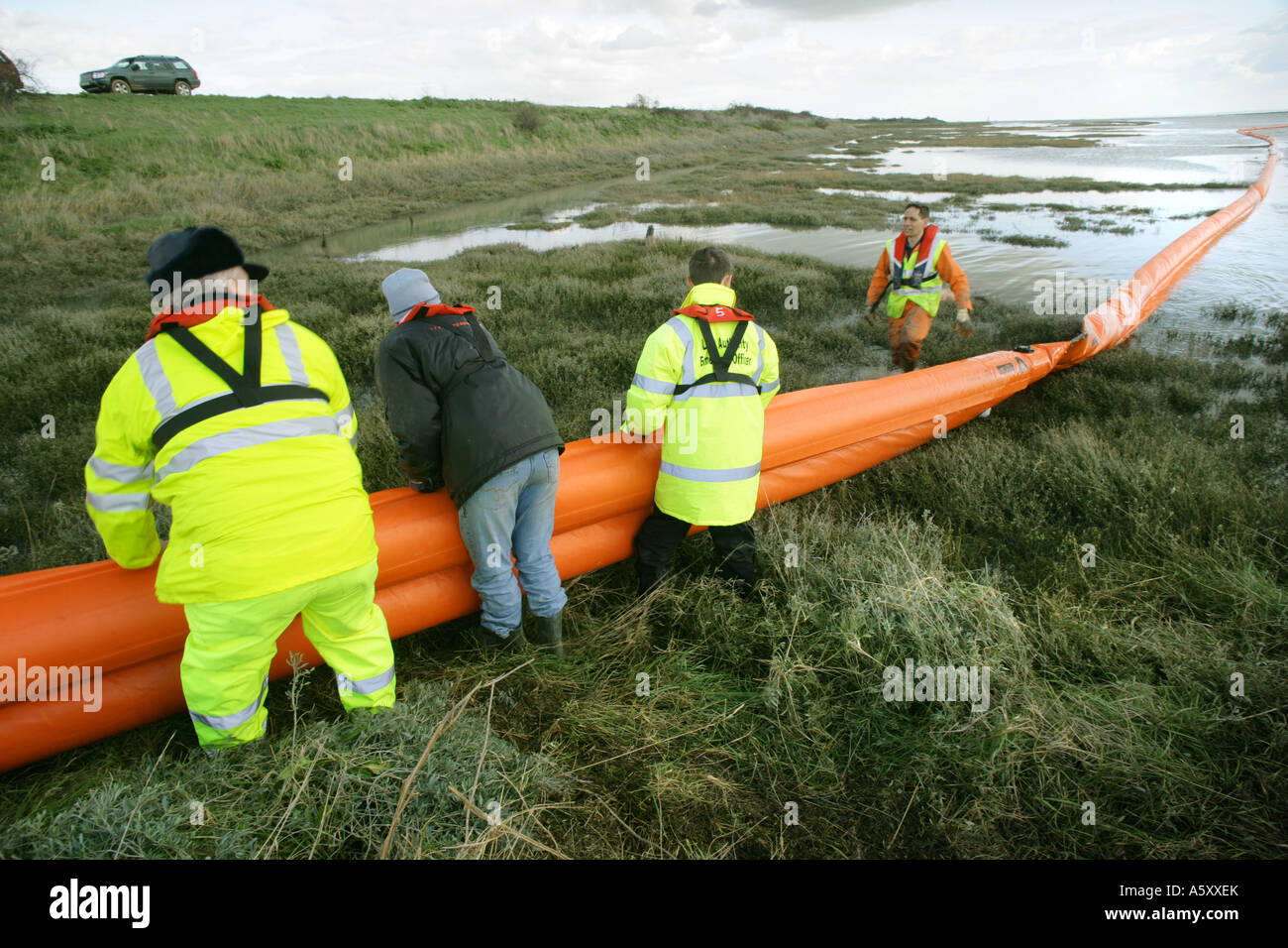 EMERGENCY WORKERS PUT A BOOM IN PLACE during a mock oil spill exercise ...