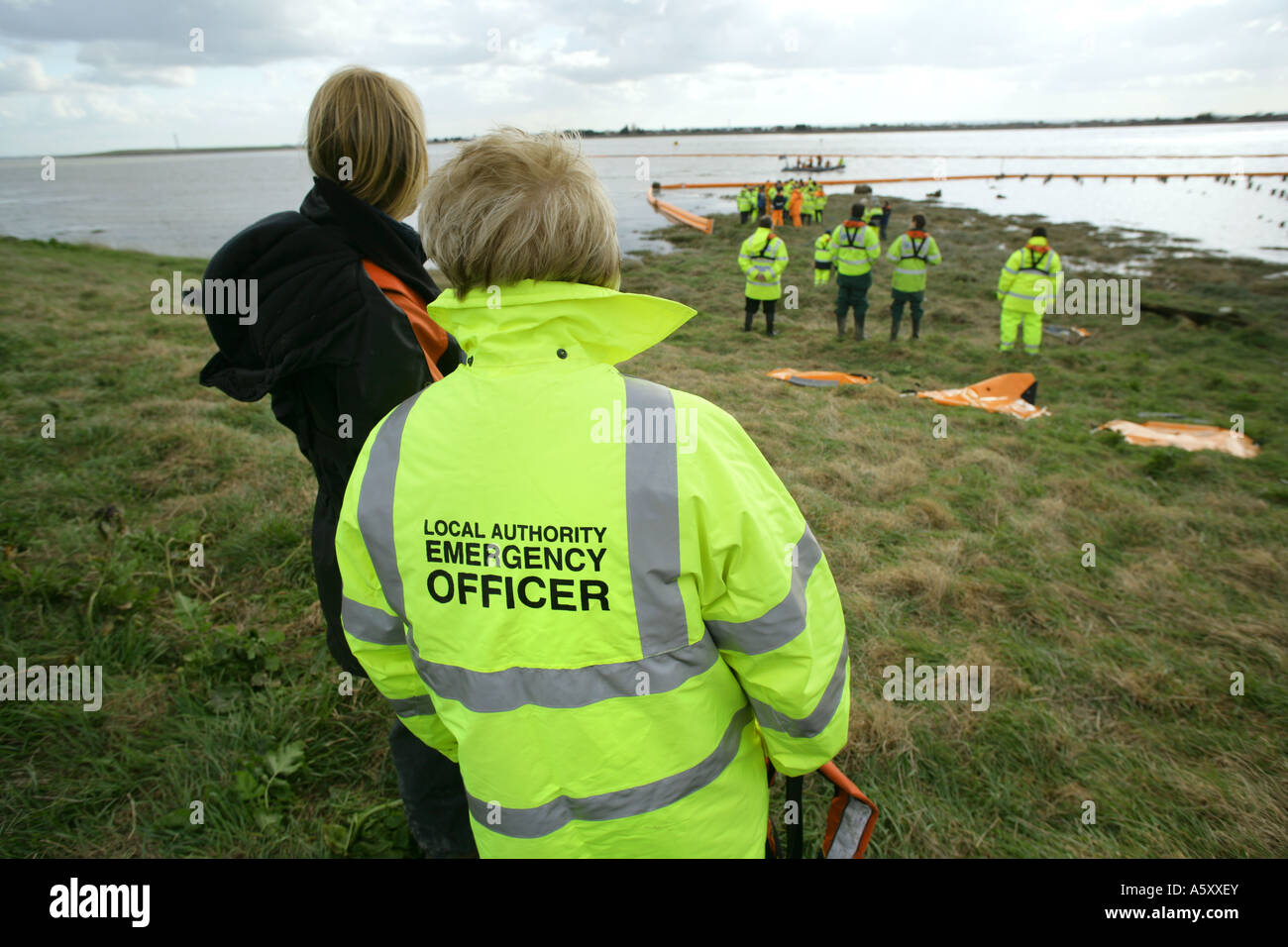 EMERGENCY WORKERS PUT A BOOM IN PLACE during a mock oil spill exercise ...