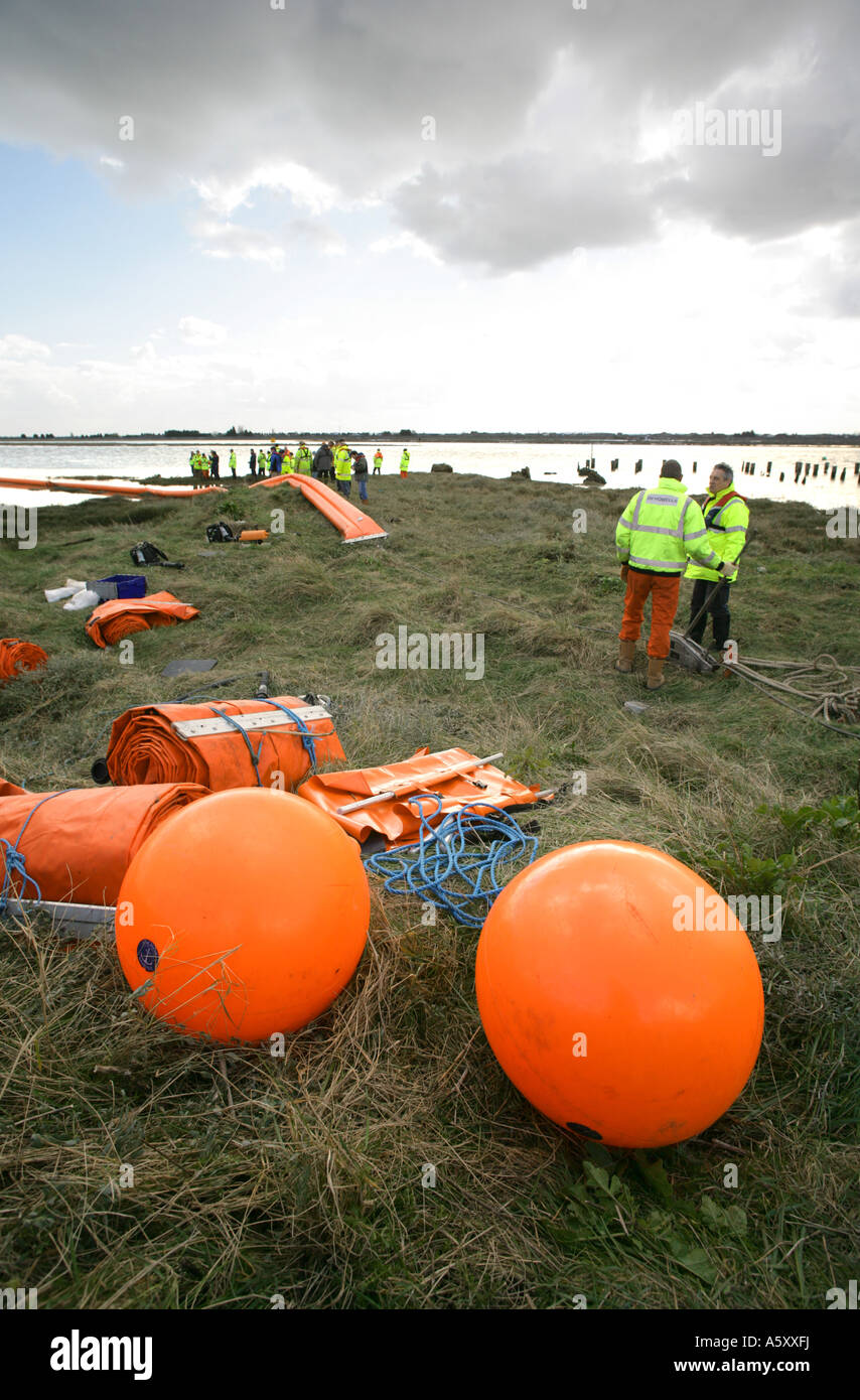 EMERGENCY WORKERS PUT A BOOM IN PLACE during a mock oil spill exercise ...