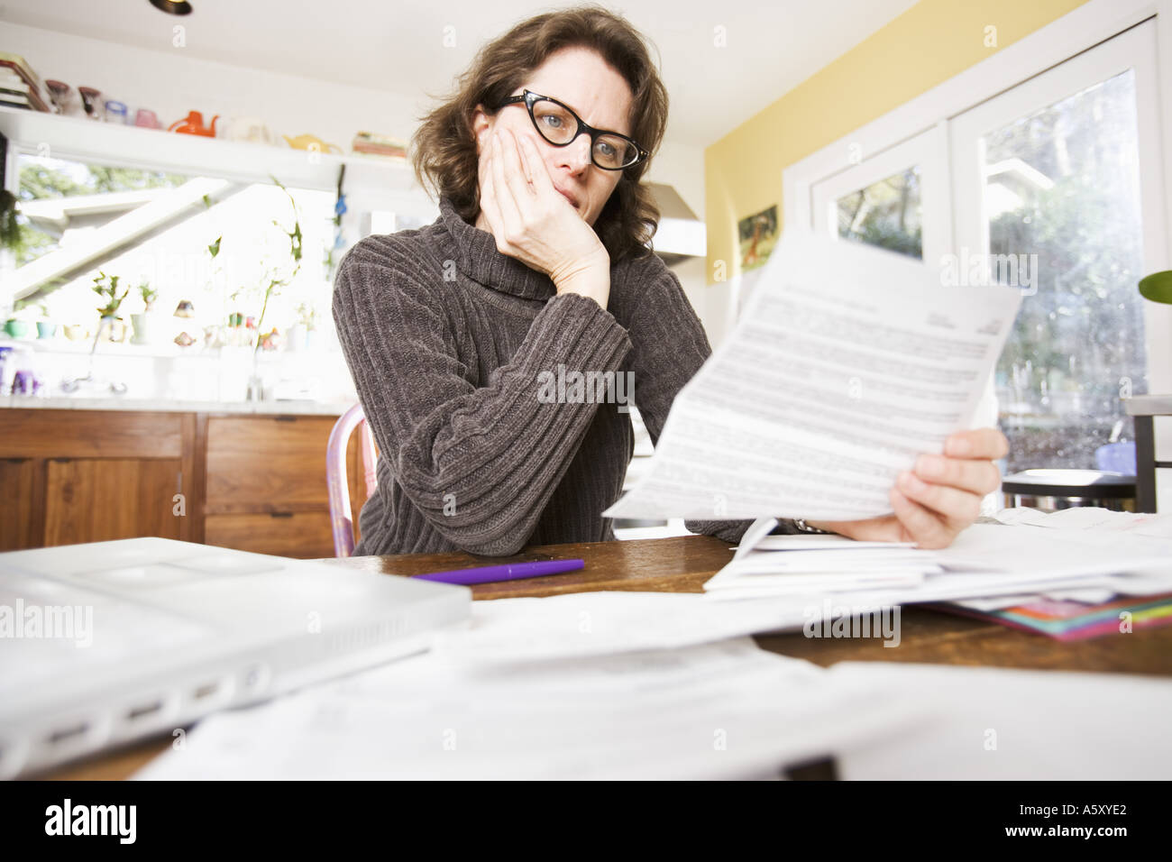 Woman reading paperwork Stock Photo - Alamy
