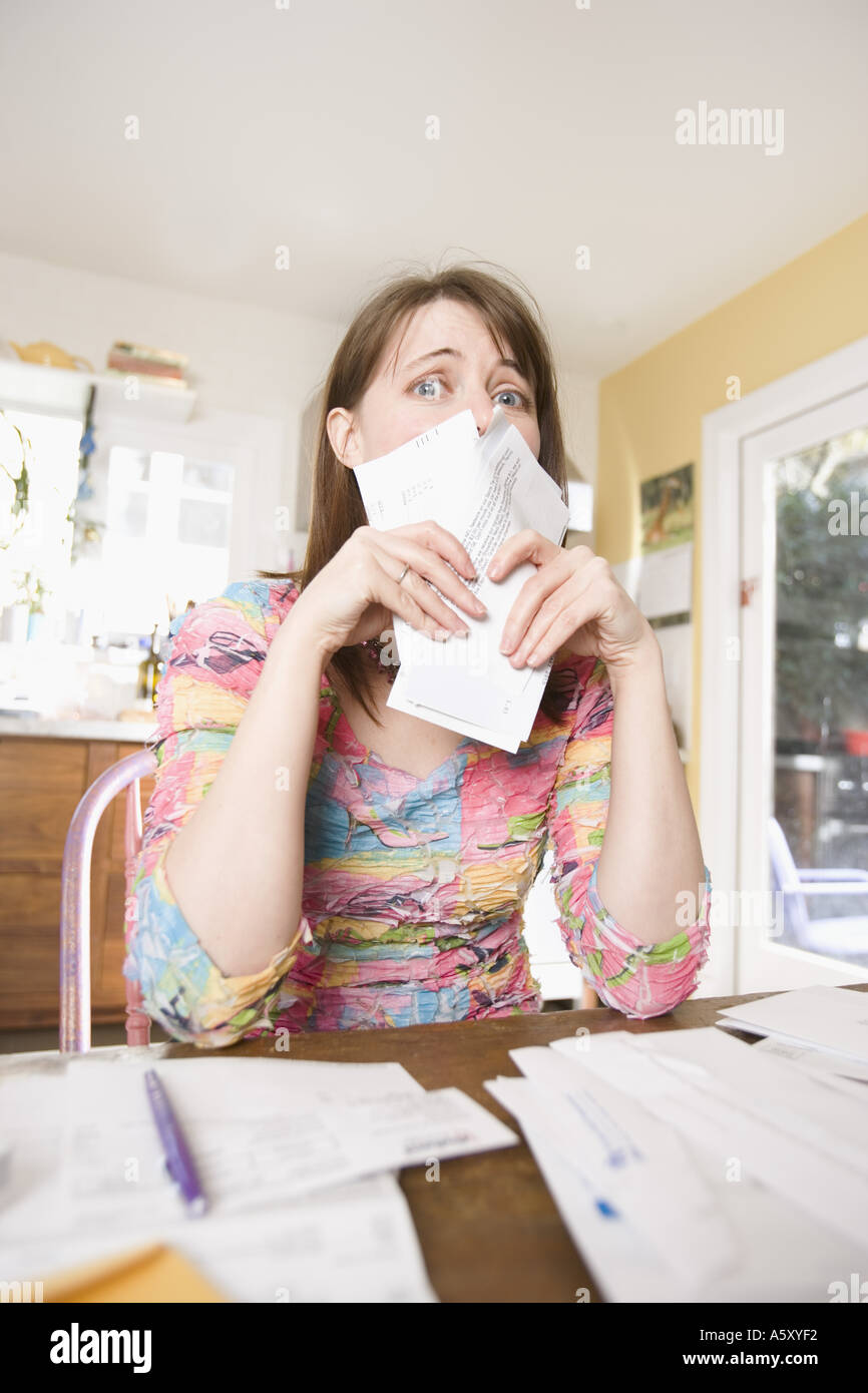 Woman sorting through bills at home Stock Photo - Alamy
