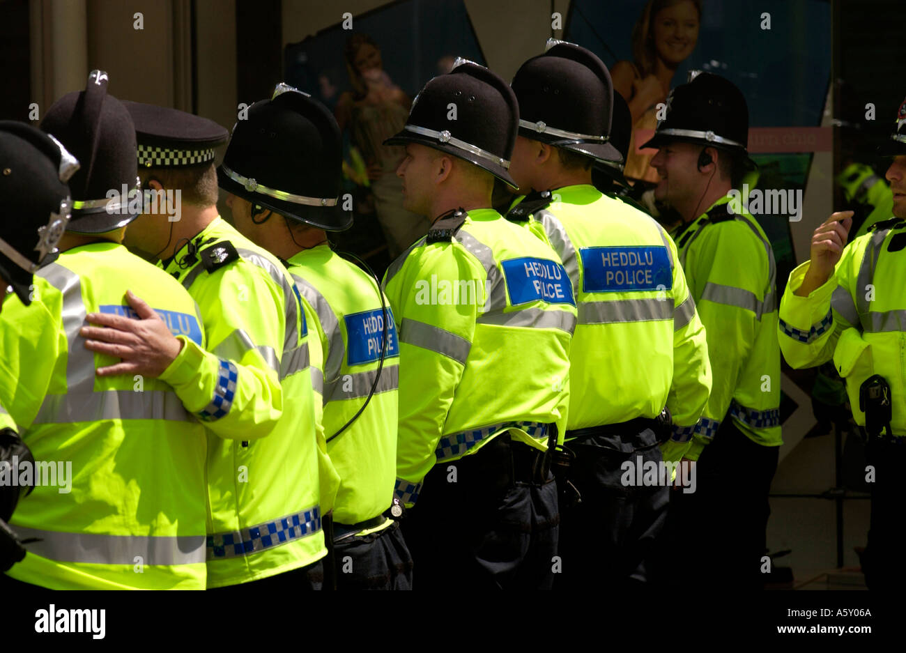 Police officers contain a group of football fans in Cardiff city centre ...