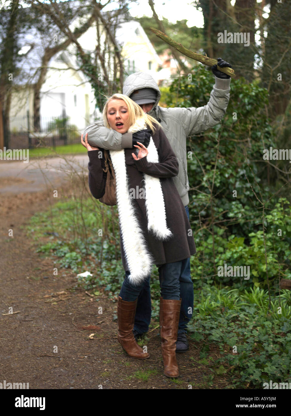 Young Woman Walking On A Quiet Public Path Being Threatened By A ...