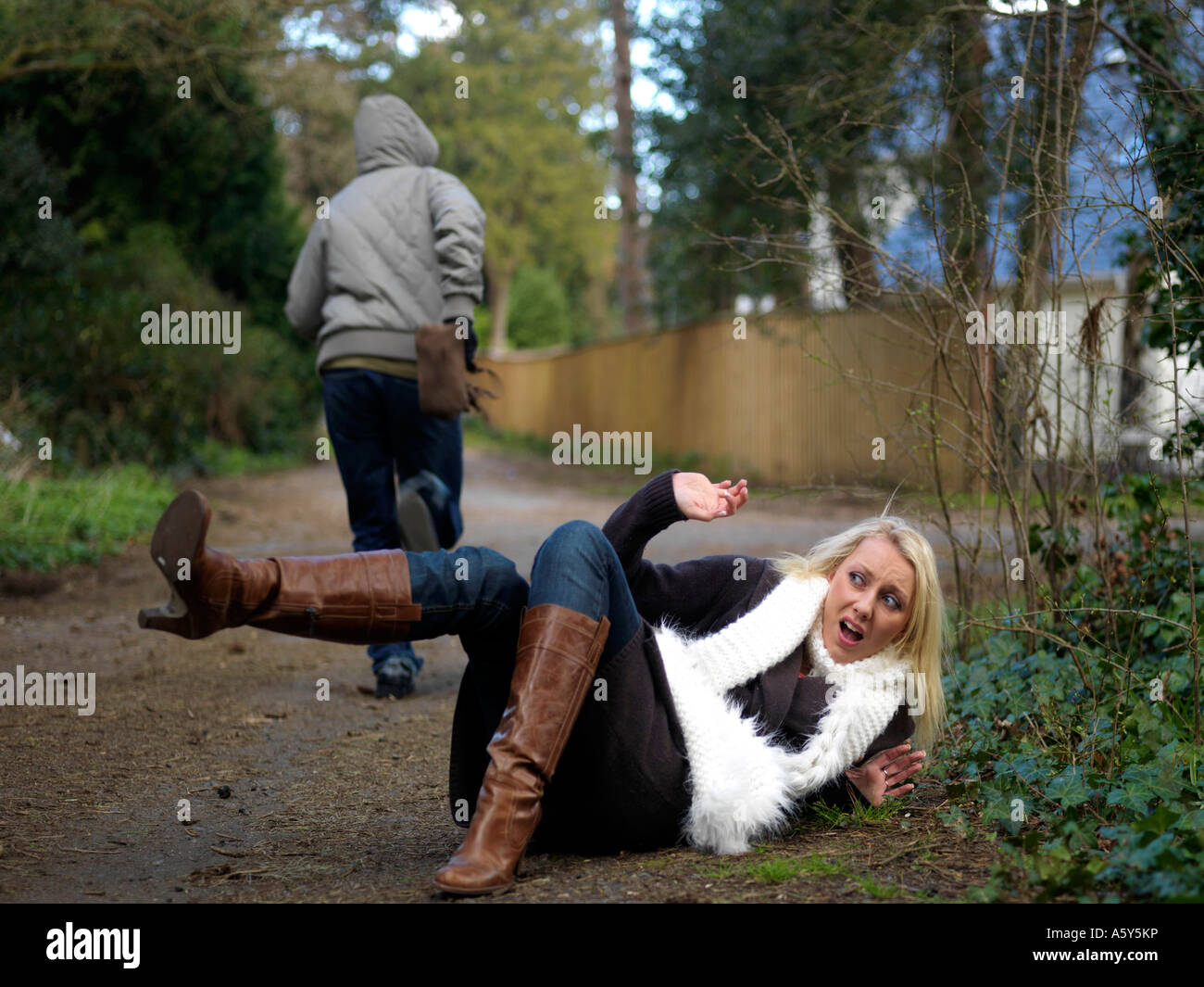 Young Woman Walking On A Quiet Public Path Being Threatened By A ...