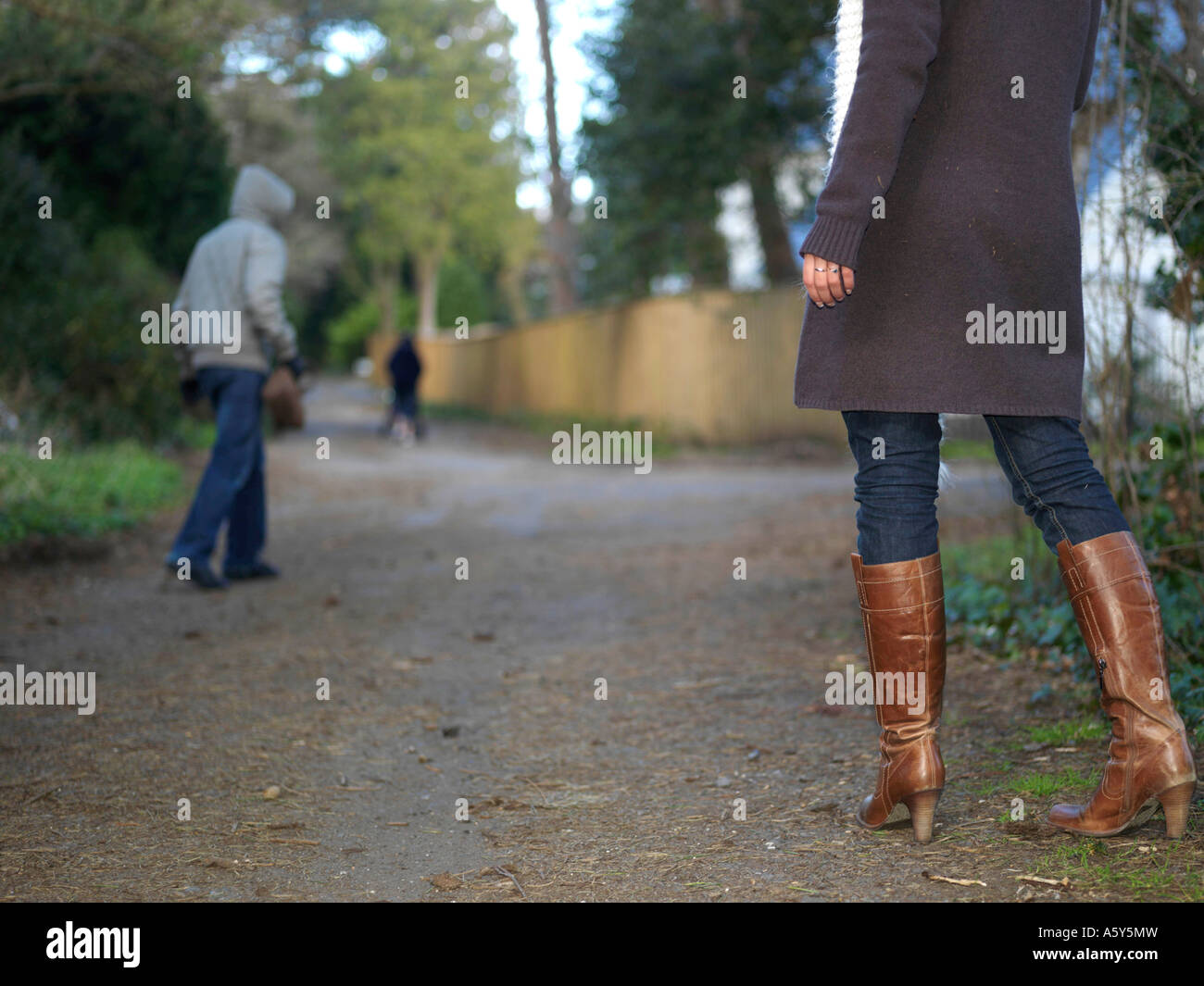 Young Woman Walking On A Quiet Public Path Being Threatened By A ...
