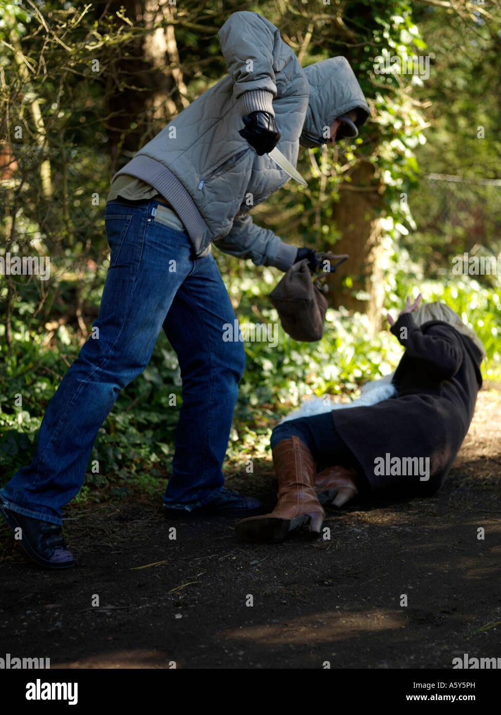Young Woman Walking On A Quiet Public Path Being Threatened By A ...