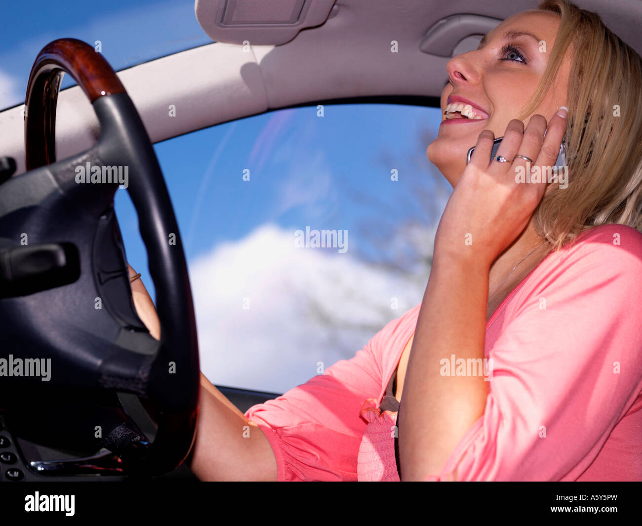 Young Woman Driver Illegally Using A Mobile Cell Phone White Driving A ...