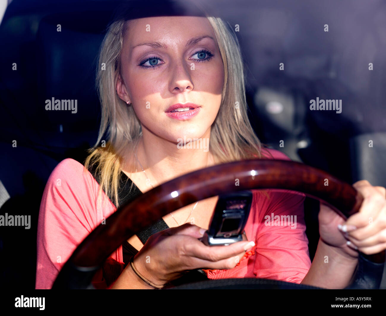 Young Woman Driver Illegally Using A Mobile Cell Phone White Driving A ...