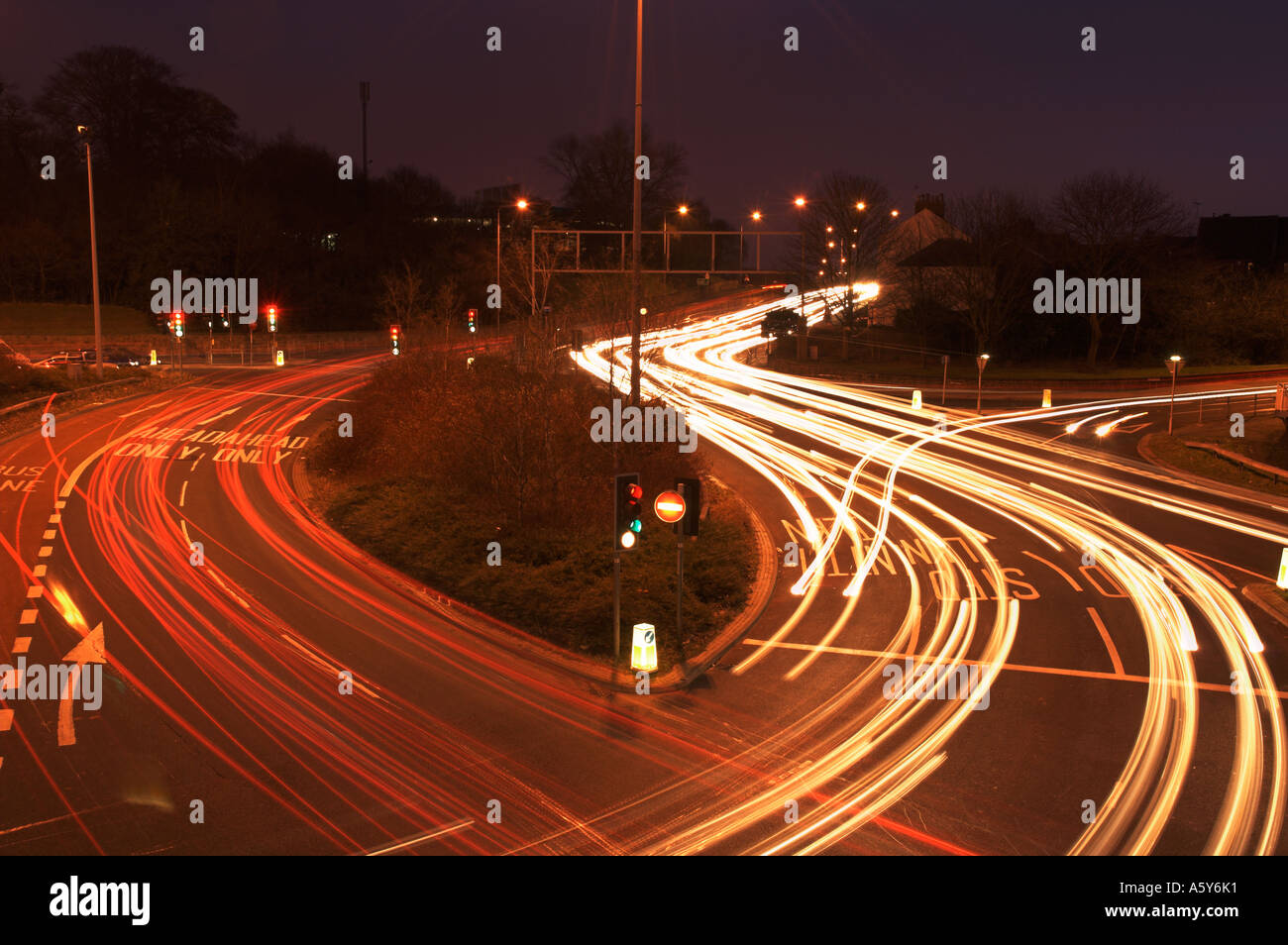 Light trails caused by traffic at a busy road junction with traffic ...