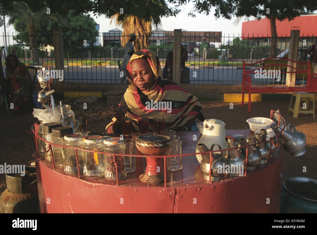 A Sudanese woman preparing tea and coffee in a park, Khartoum, Sudan ...