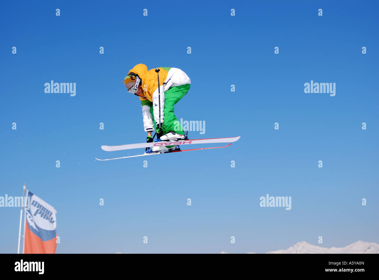 skier performing aerial tricks with view of mountain and valley in the ...