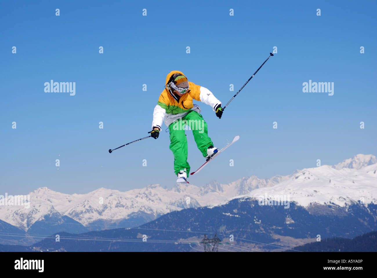 skier performing aerial tricks with view of mountain and valley in the ...