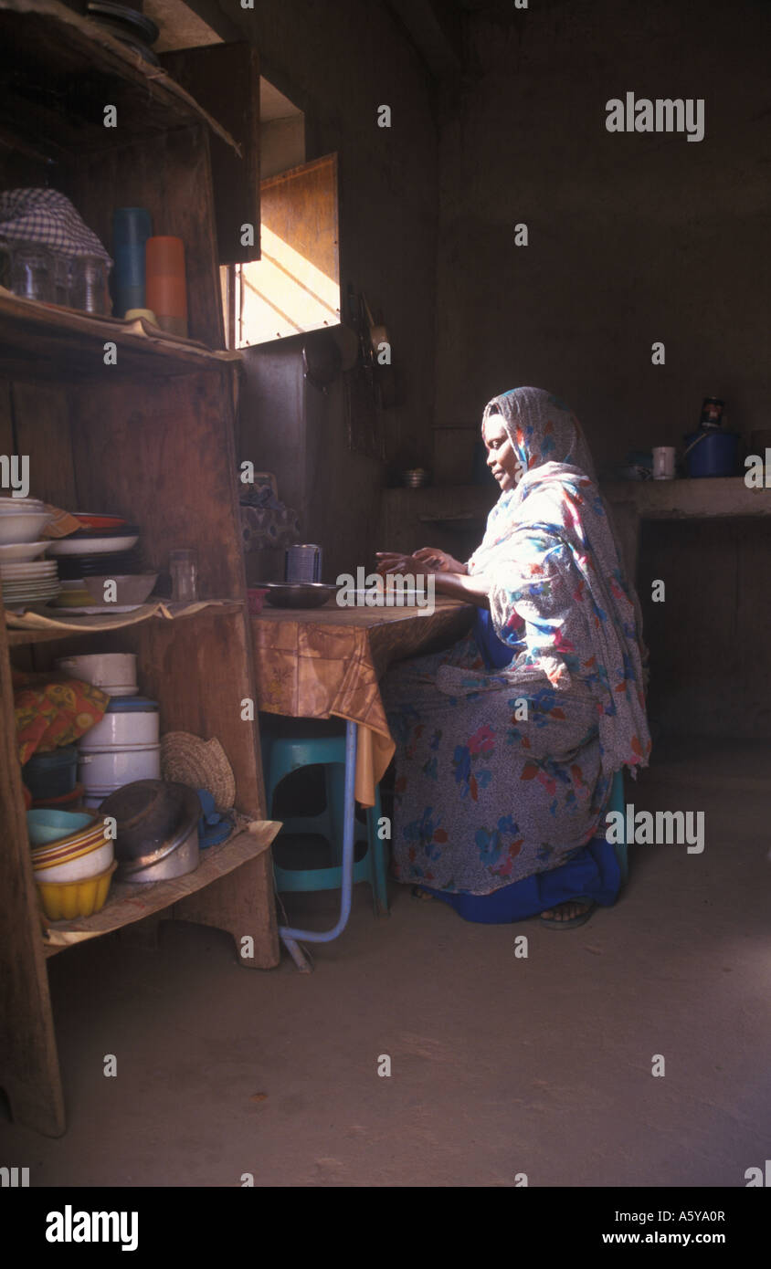 Sudanese woman in the kitchen wearing the traditional dress called Tob ...