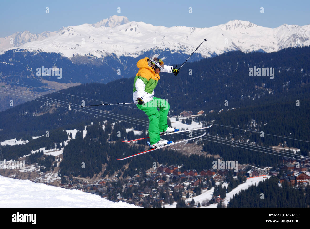 skier performing aerial tricks with view of mountain and valley in the ...
