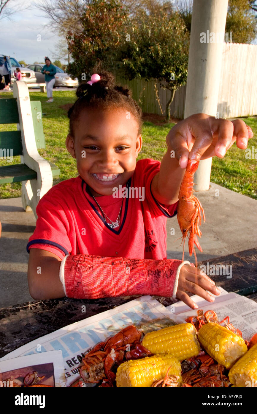 African american girls eating crawfish and corn on the cob in New ...