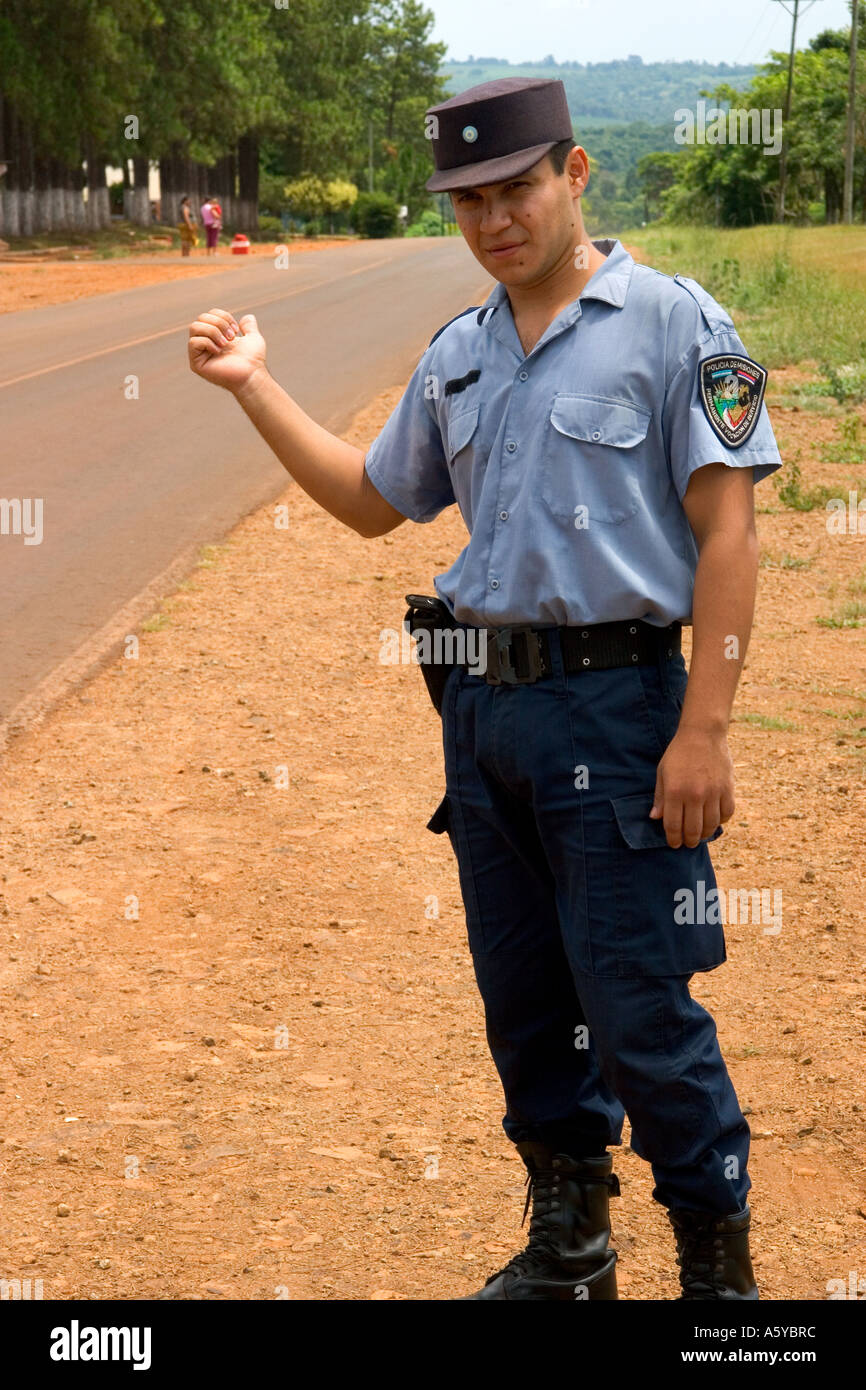 A police officer hitch hiking on the side of a road in Argentina Stock ...
