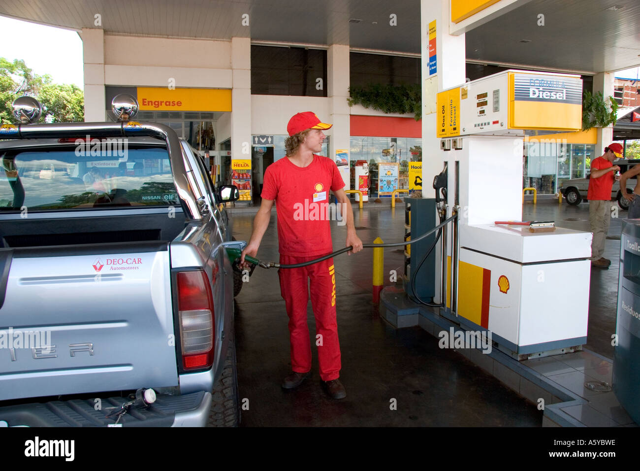 Worker pumping gas at a gas station in Argentina Stock Photo - Alamy