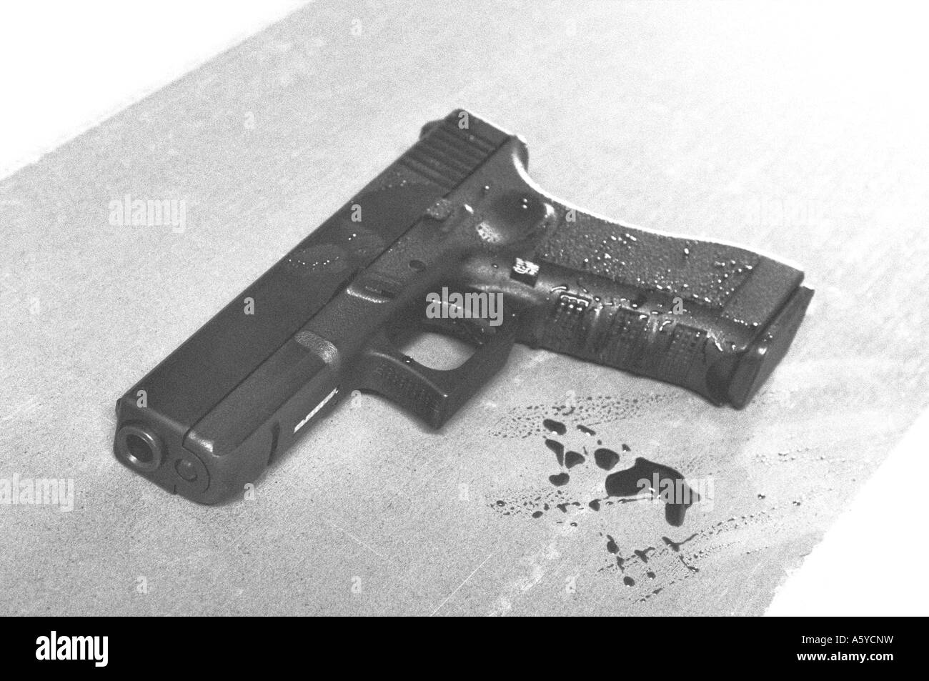 a glock automatic pistol with bloodstains in black and white (replica ...