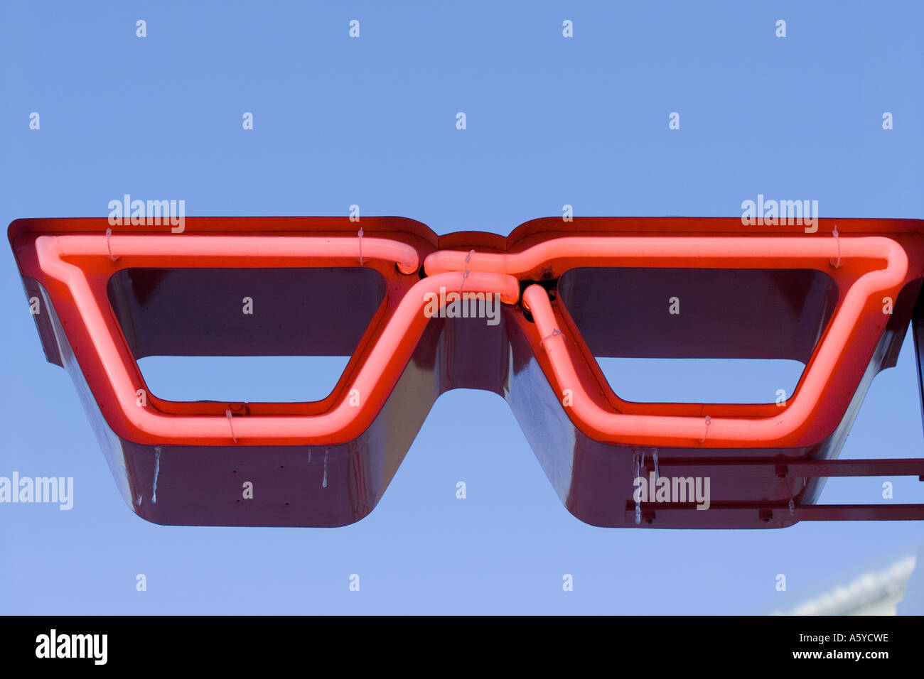 Optician´s neon sign against blue sky Stock Photo - Alamy