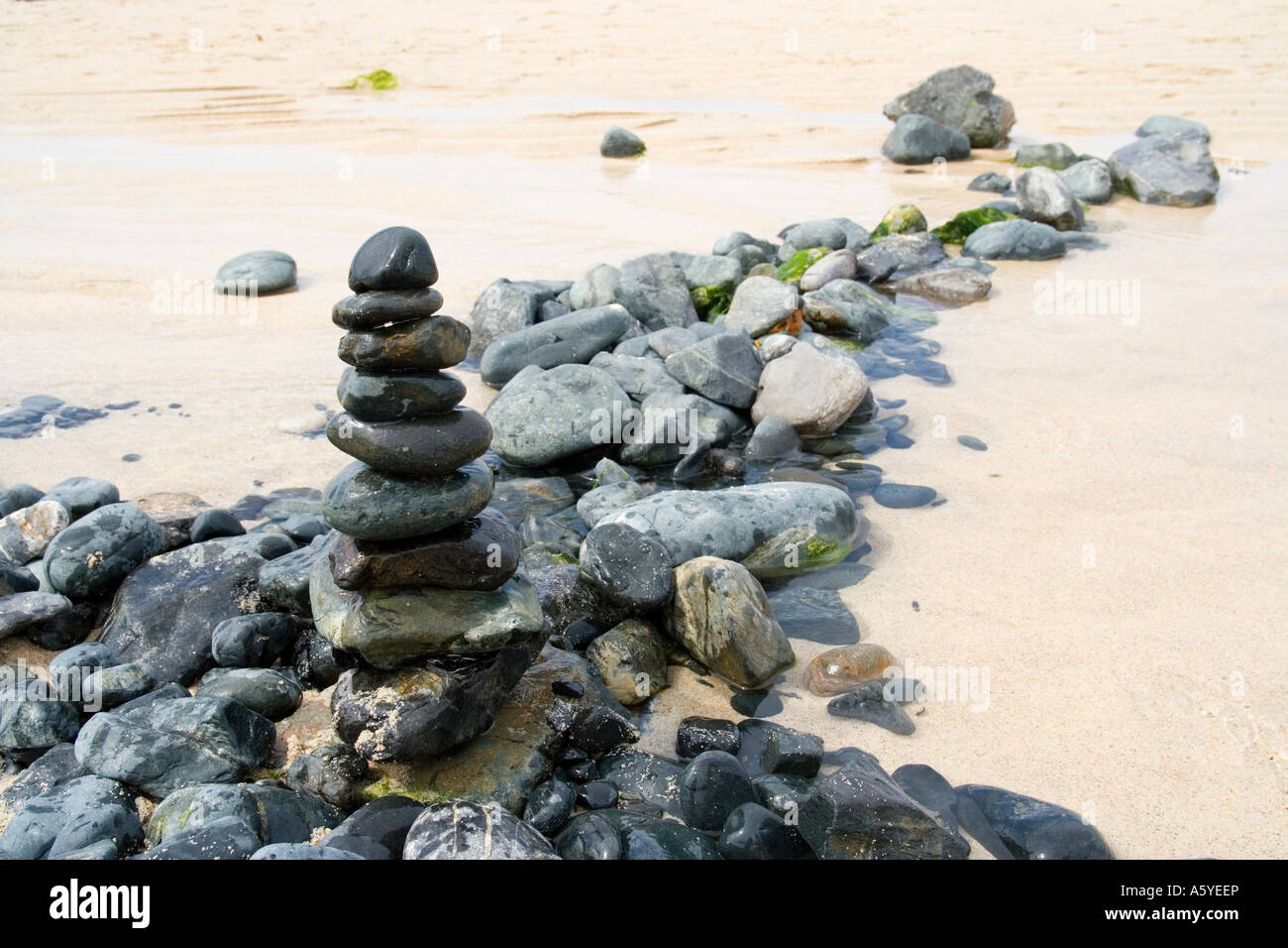 Small pile of balanced pebbles on beach Stock Photo - Alamy