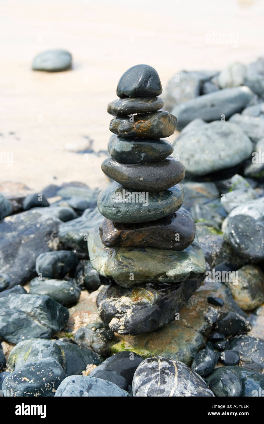 Small pile of balanced pebbles on beach Stock Photo - Alamy
