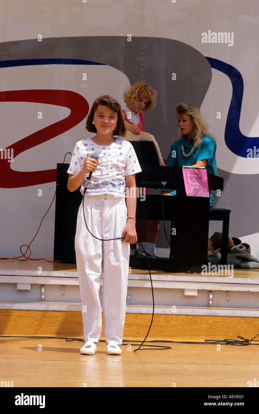 A young female singer on stage Stock Photo - Alamy