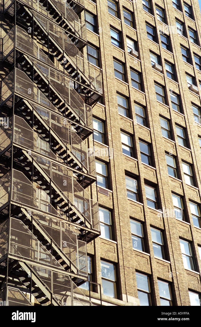 Looking up at a fire escape on a tall residential building in Manhattan ...