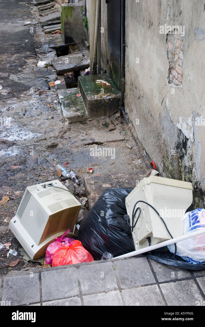 Modern garbage discarded computer monitors amongst rubbish in a back ...