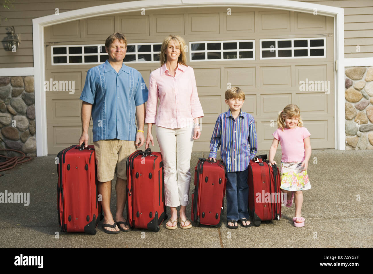 Family standing together with luggage Stock Photo - Alamy