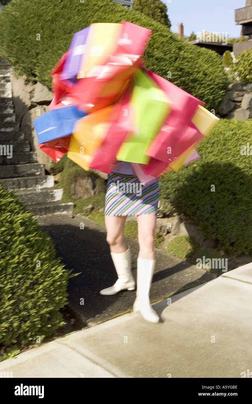 Woman carrying many shopping bags Stock Photo - Alamy