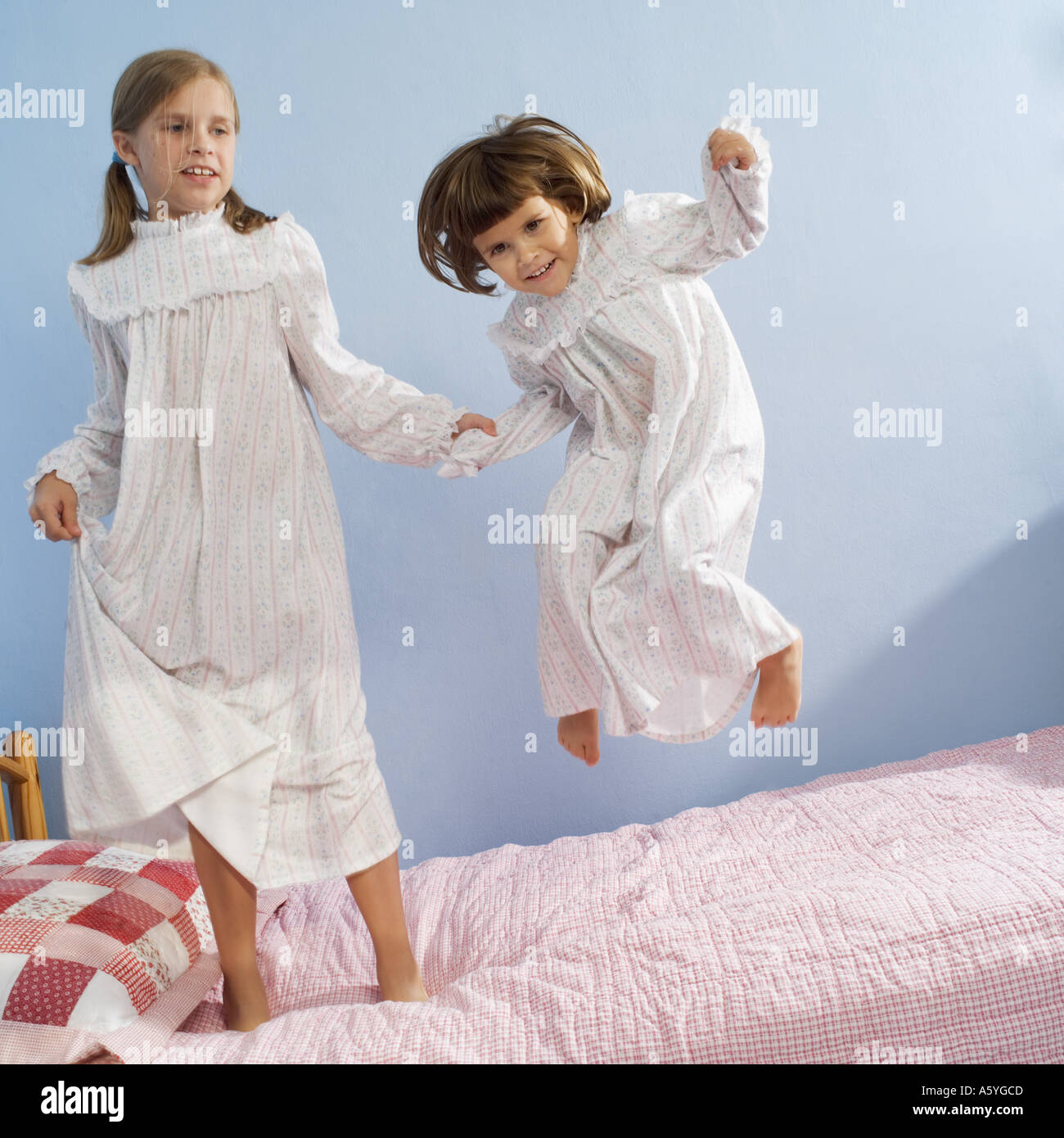 Girls jumping on bed Stock Photo - Alamy