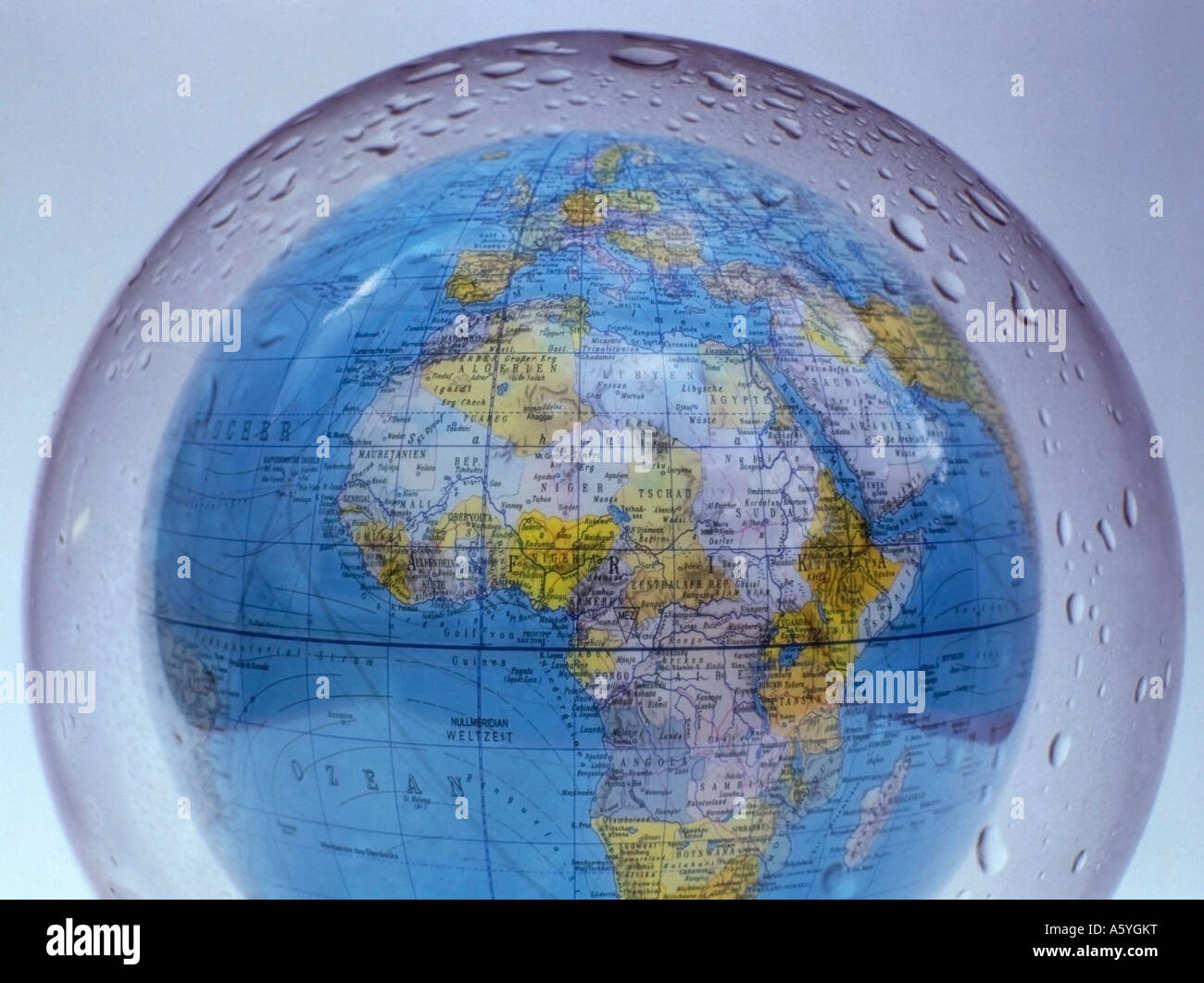 man destroying the earth terrestial globe in closed steaming glas globe ...