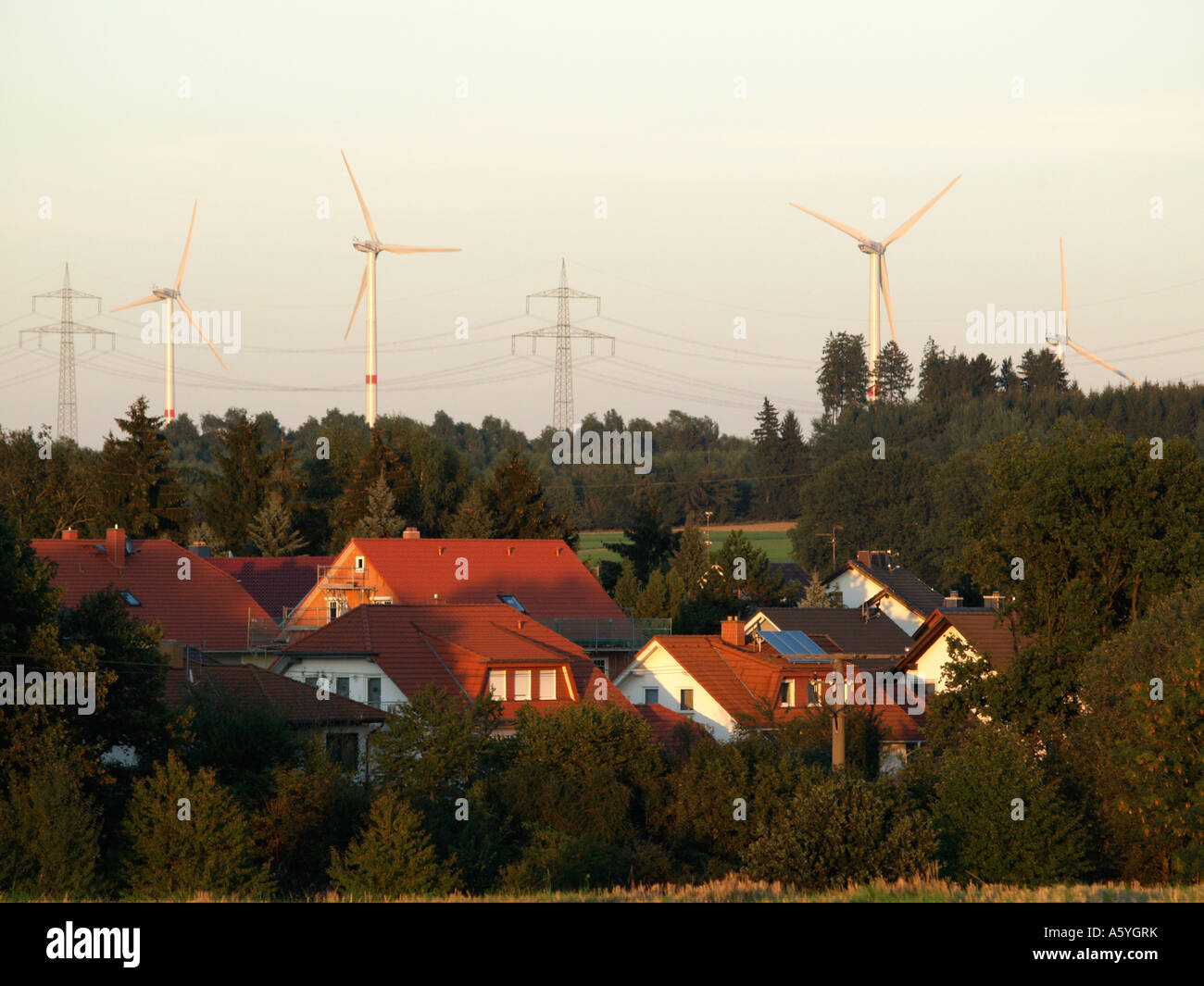 wind power station wind wheel behind a village in country landscape of ...
