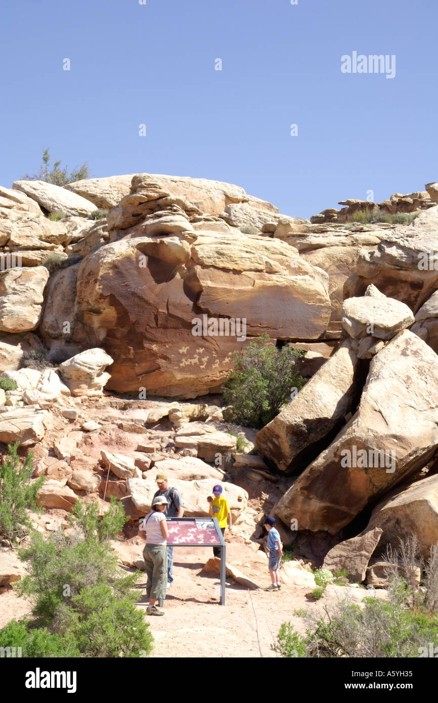 family viewing native american petrogylphs Arches National Park Utah U ...