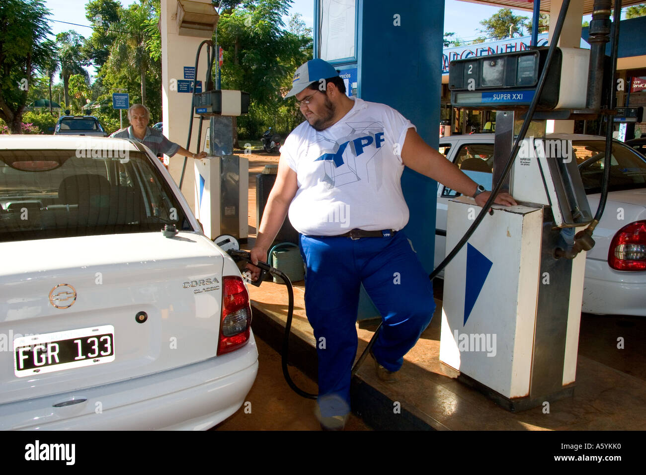 Man pumping gas at a gas station in Argentina Stock Photo - Alamy