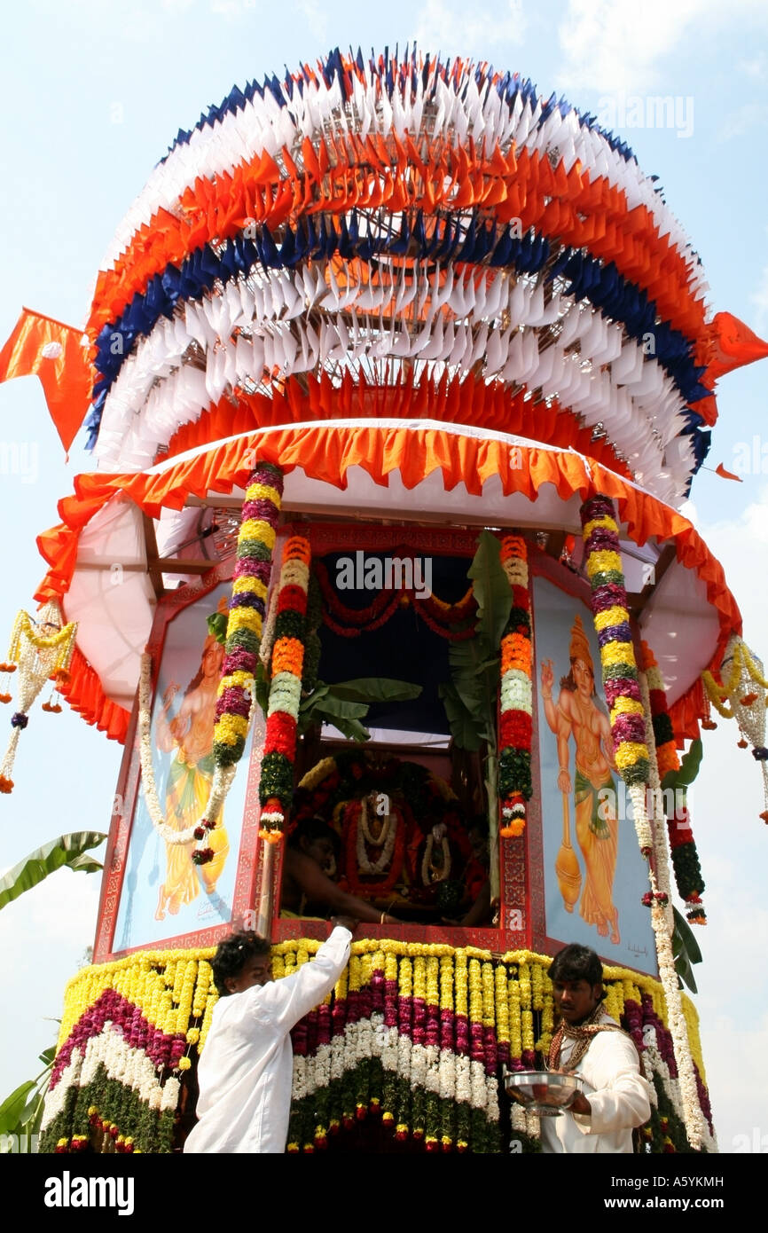 Large decorated chariot carrying priests and Hindu idols moves along ...