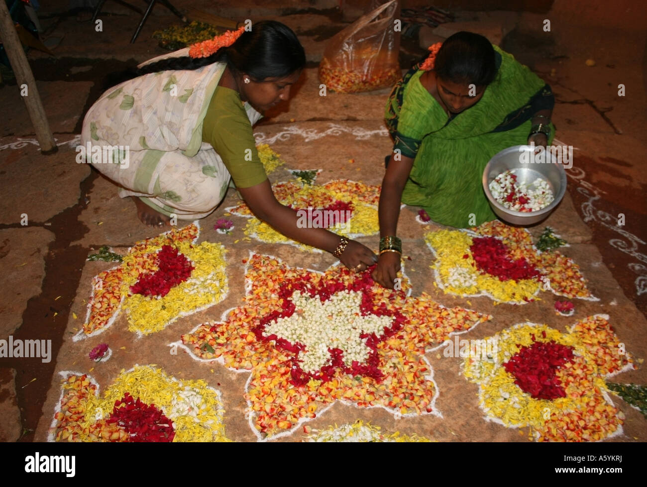 Women make flower rangoli pattern for the Karaga Festival , Bangalore ...