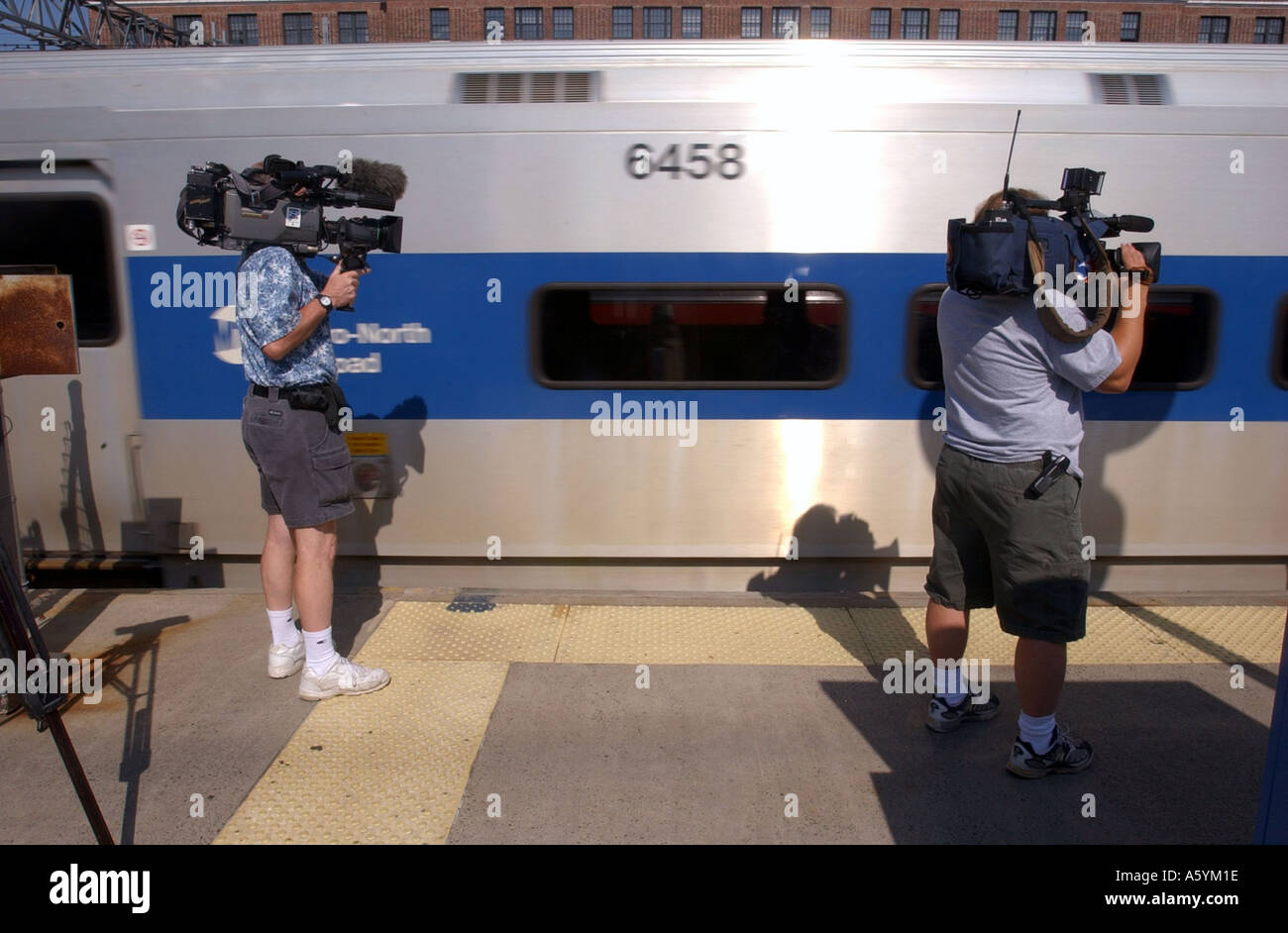 Video camera operators camera men film a moving train Stock Photo - Alamy