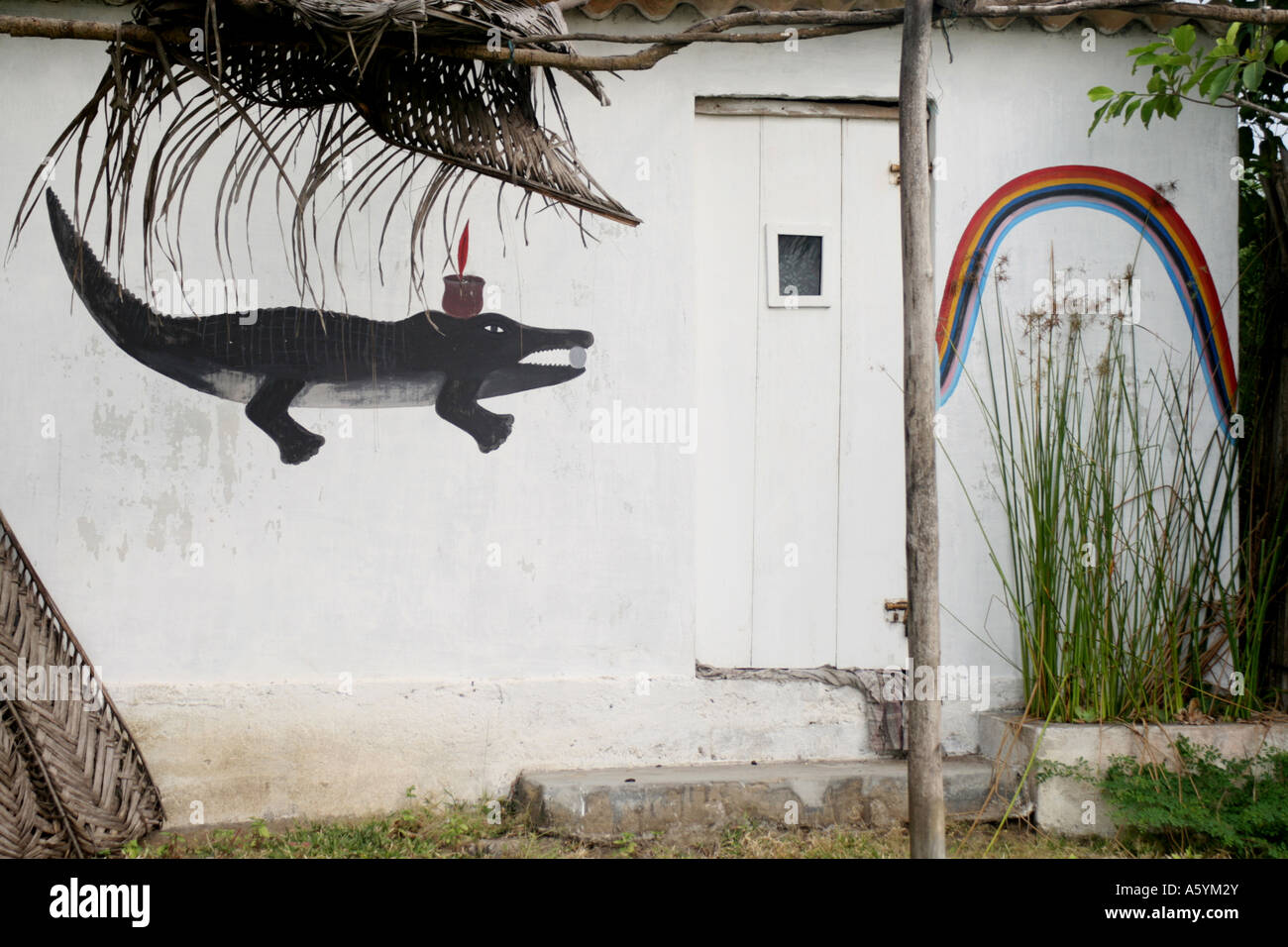 Voodoo temple with crocodile, a sign of fertility and rainbow, sign of ...
