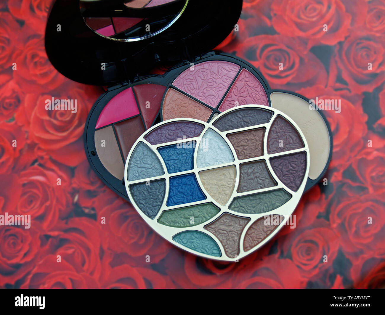make up box in form of a heart on background with red roses Stock Photo ...