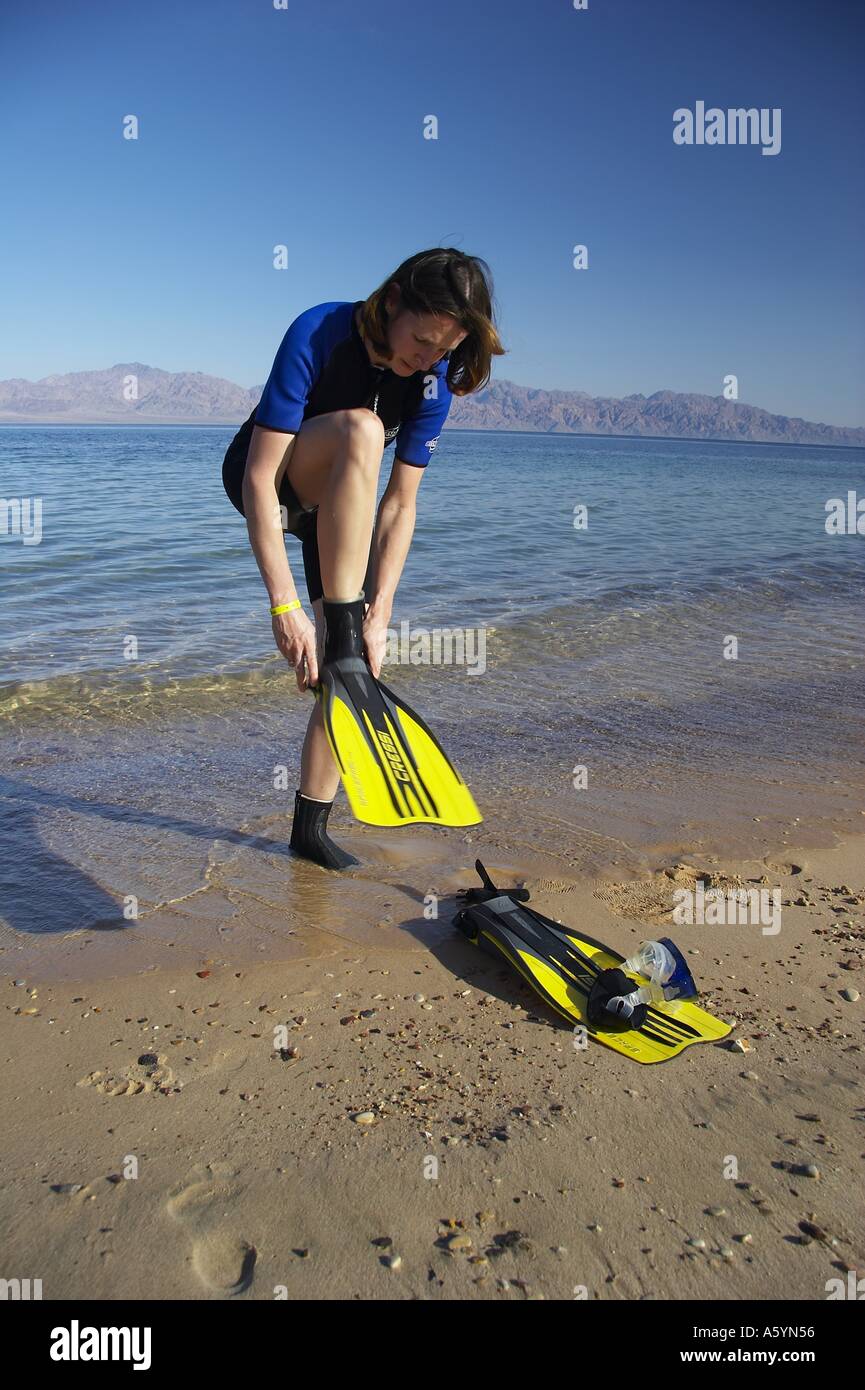 woman putting on fins / snorkeling Stock Photo - Alamy