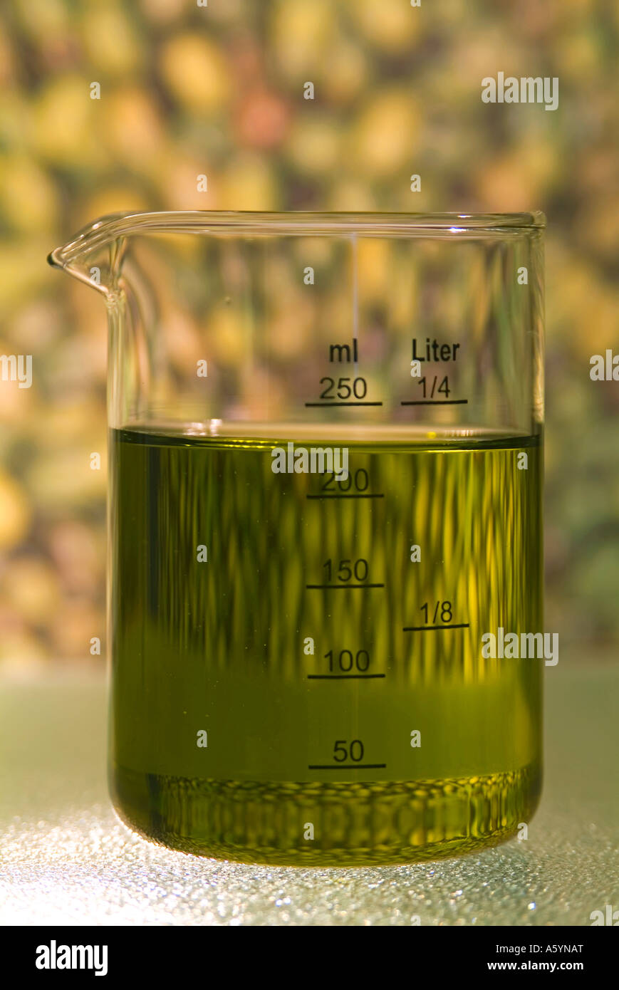 measuring jar glas filled with greece olive oil Stock Photo - Alamy