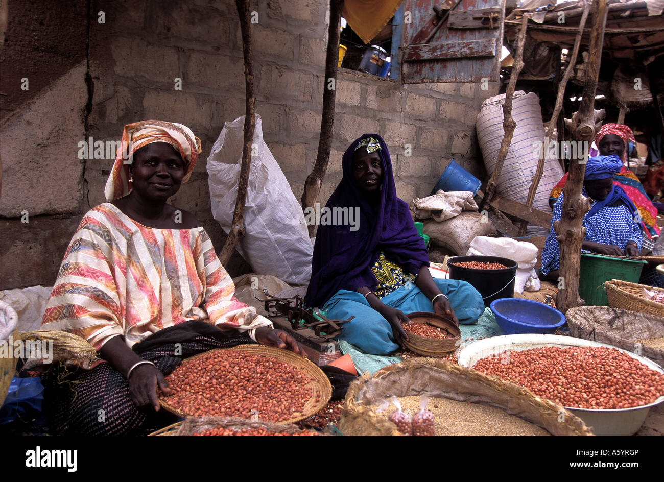 Senegalese women selling peanuts in an open air market near Dakar ...