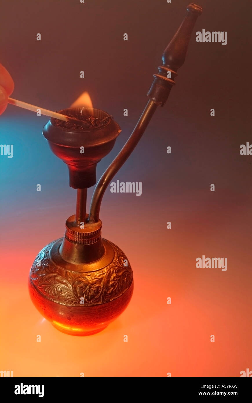 hand lighting a bong hookah with a match Stock Photo - Alamy