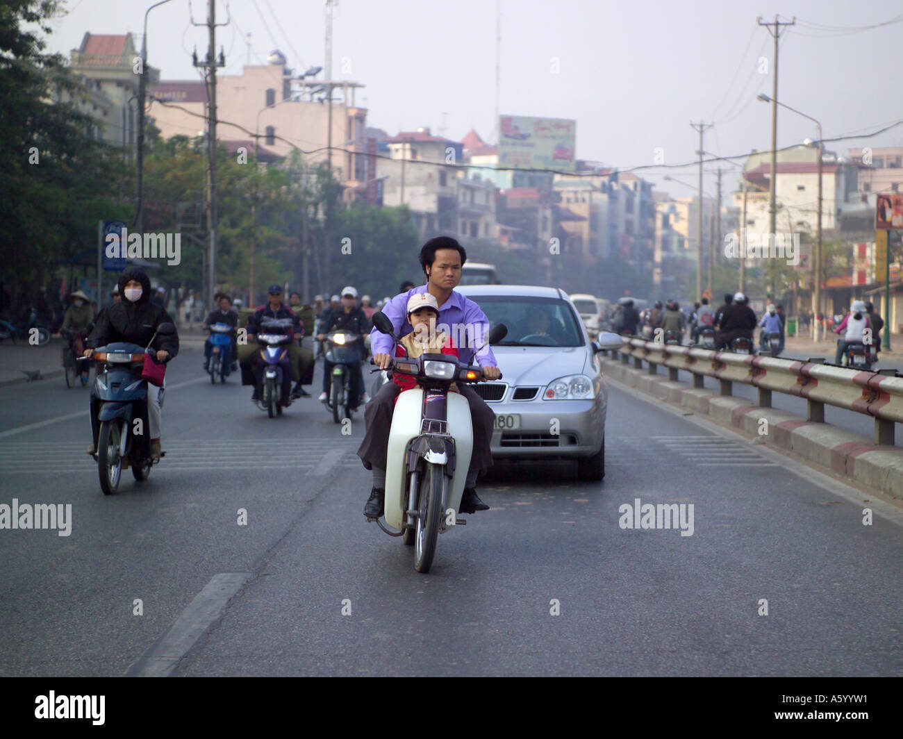Child on scooter with father in rush hour traffic Stock Photo - Alamy