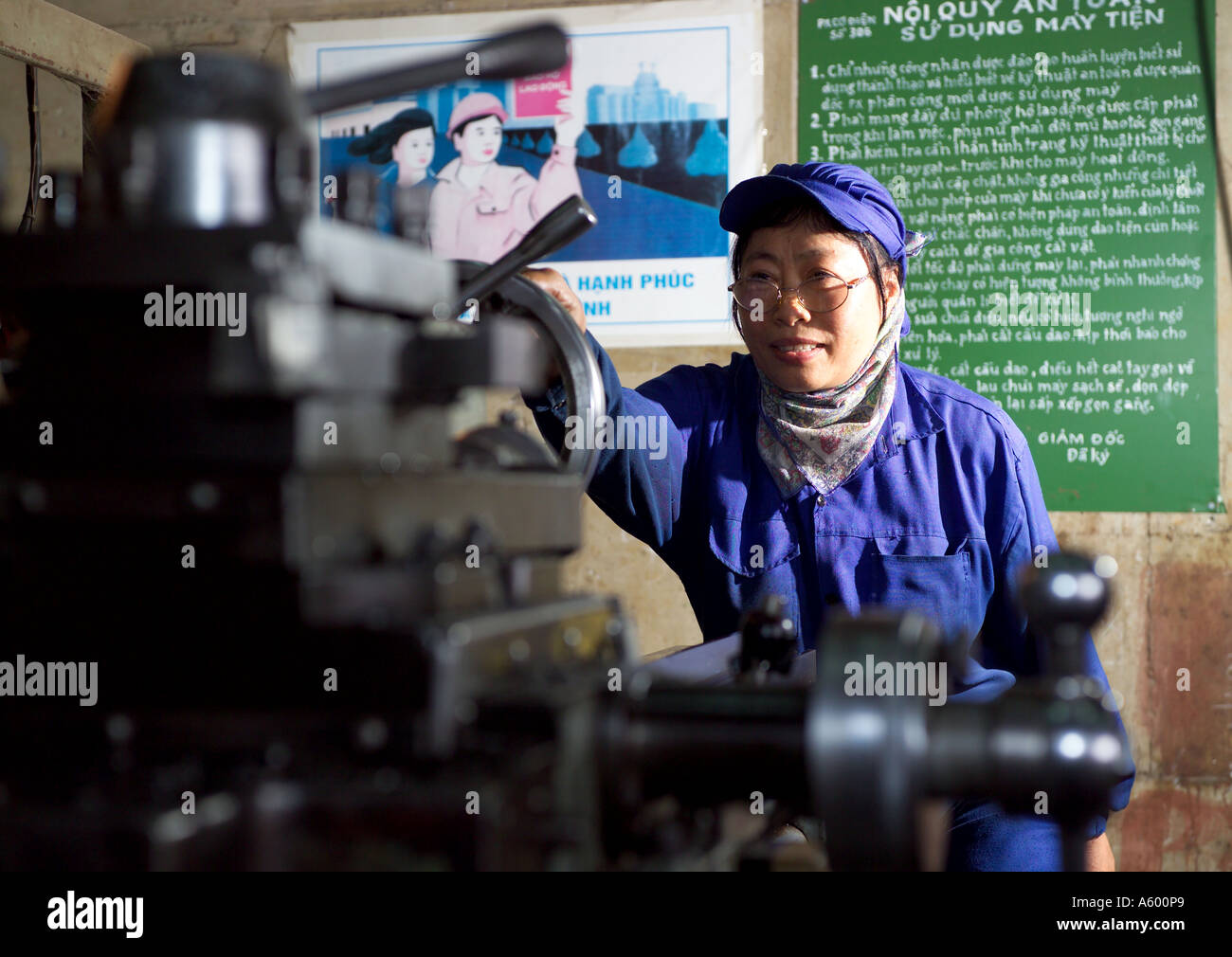 Female Vietnamese shipyard worker, operating a lathe, Asia Stock Photo ...