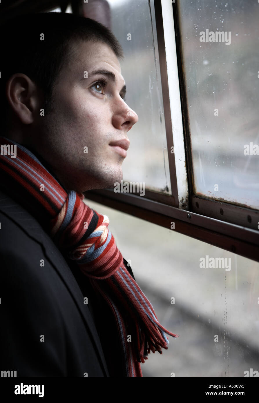 Young Business professional man looking through window Stock Photo - Alamy